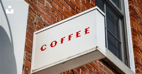 벽돌 건물에 있는 간판의 클로즈업 사진 Unsplash의 무료 커피숍 간판 이미지