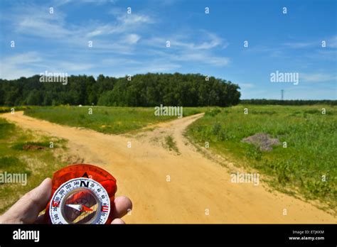 With The Compass Before The Fork The Magnetic Compass In The Hand Of A Man To A Fork In The