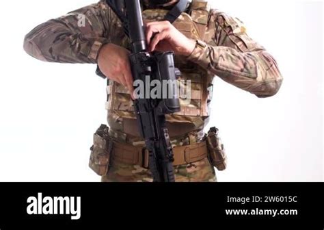 Special Forces Scout In Multicam Tactical Gear Picks Up A Combat Rifle And Attaches It To His