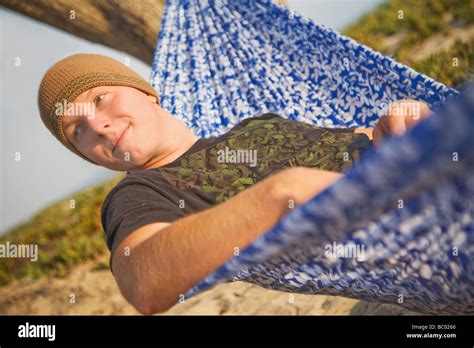A Man Relaxing In A Hammock On The Beach Stock Photo Alamy