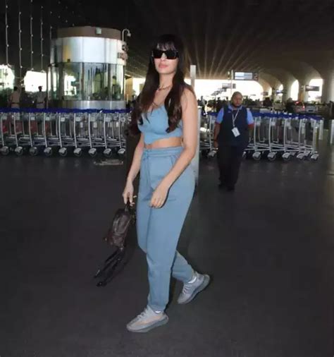 Nora Fatehi Wearing A Deep Neck Top Showing Her Stomach Was Spotted At The Airport The Style