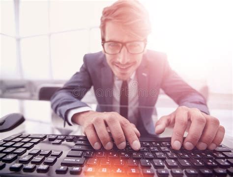 Young Man Using Keyboard Closely And Carefully Looking At The Stock