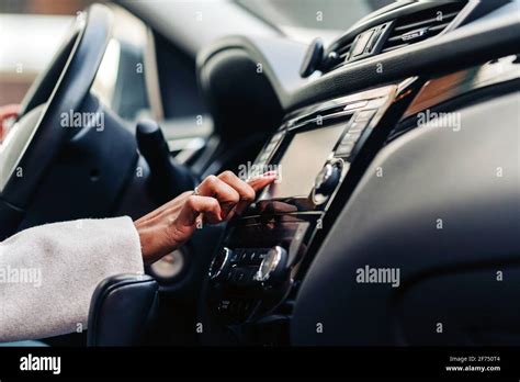Crop Anonymous Female Touching Screen Of Multimedia Control Panel In Luxury Automobile In