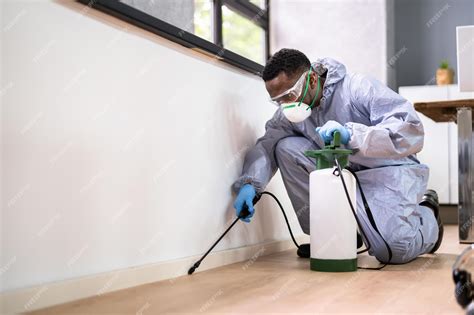 Premium Photo Pest Control Exterminator Man Spraying Termite Pesticide