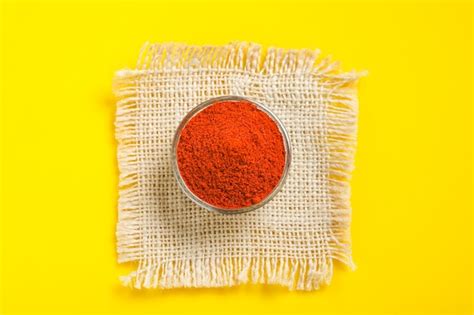 Premium Photo Red Chilli Powder In Glass Bowl On Yellow Surface