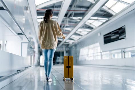 Asian Beautiful Woman With Luggage And Walking In Airport Stock Image