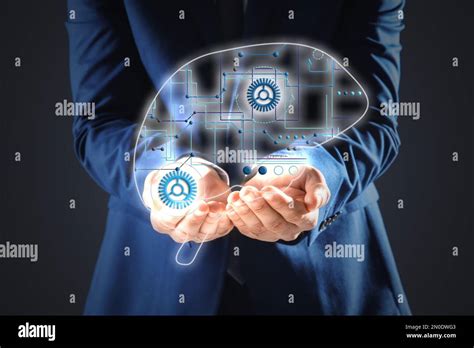 Businessman Demonstrating Digital Image Of Brain On Dark Background