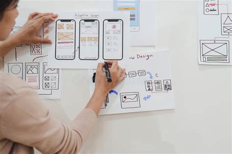 Close Up Ux Developer And Ui Designer Brainstorming Interface Wireframe