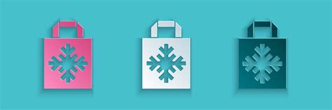 종이 는 파란색 배경에 고립 된 눈송이 아이콘크리스마스 종이 쇼핑 백을 잘라 패키지 기호입니다 메리 크리스마스와 새해 복 많은 새해 종이 아트 스타일 벡터 3차원 형태에