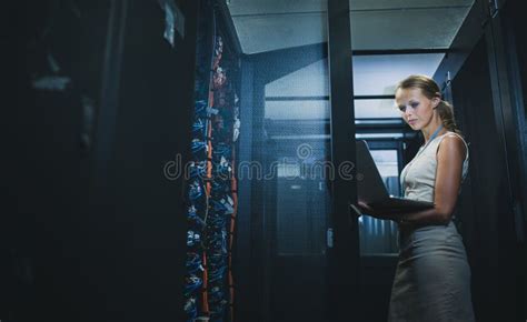 It Engineer Standing Before Working Server Rack Doing Diagnostics Using Laptop Stock Image