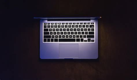 free photo top view of a laptop on a table glowing screen in the dark