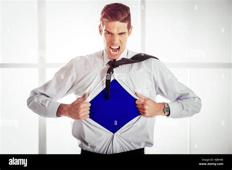 Angry Businessman Ripping Open His Shirt And Exposing A Superhero Blue Costume Underneath