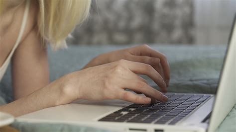 Premium Photo Female Hand Print On A Laptop Close Up Woman Works For A Laptop While Lying In