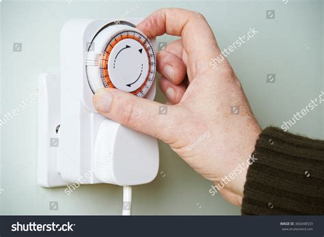Man Adjusting Timer On Electrical Socket Stock Photo Shutterstock