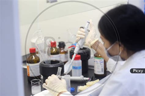 Image Of Asian Woman Scientist Using Pipette To Make An Experiment In The Laboratory LV804926 Picxy