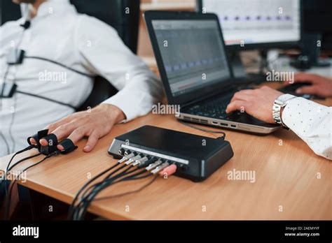 Work In Progress Suspicious Man Passes Lie Detector In The Office Asking Questions Polygraph