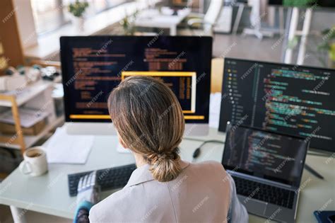 Premium Photo Female Developer Checking Programming Code On Computer View From Back