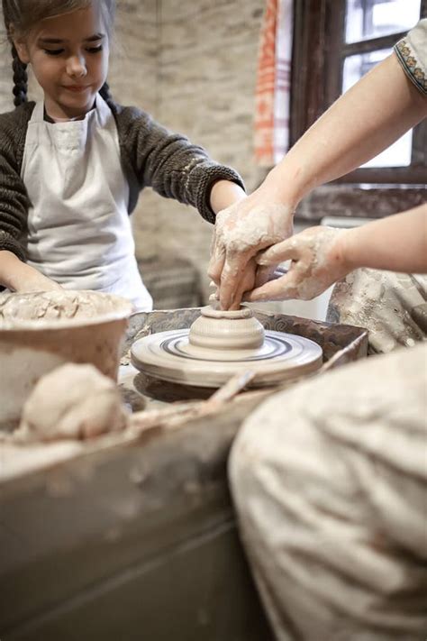 Girl Playing With Modeling Clay On Pottery Wheel At Workshop Craft Art Artisan Hobby And