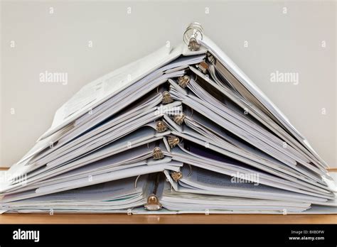 Pile Of White Binders And Paper On Desktop Stock Photo Alamy