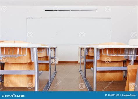 Classroom Interior With Projection Screen White Boar And Wooden Desks