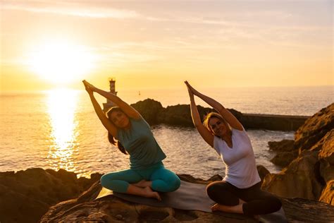 Premium Photo Two Women Sitting On Yoga Mat In Nature By The Sea At