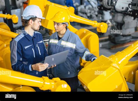 Engineer Team Working Together Inspection Quality Robot Arm In Robot