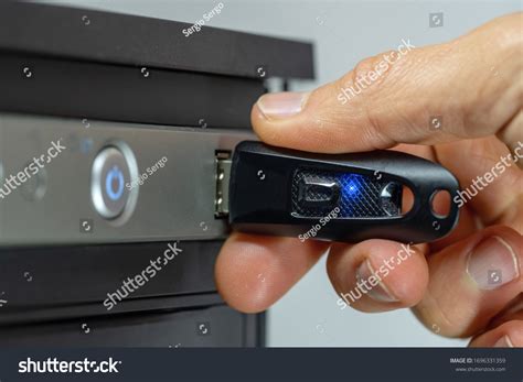 Hand Inserting Usb Flash Drive Into Stock Photo 1696331359 Shutterstock