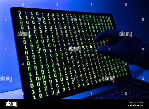 hacked or hacking computer concept gloved hand binary code and hacked