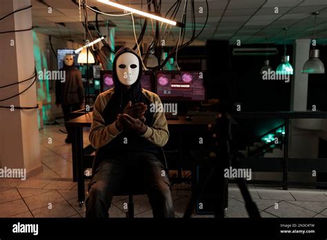 Ransomware And Internet Blackmail Concept At Night Anonymous Scammer Recording Threat Video On