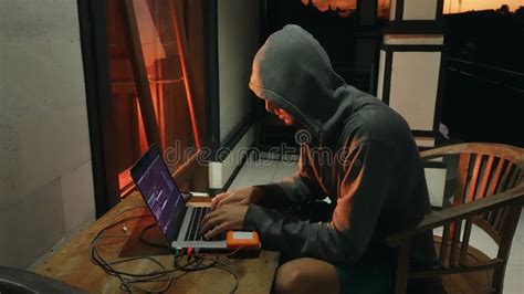 Downshifter Hacker Programmer In A Hood Creates A New Program With Viruses A Novice Programmer