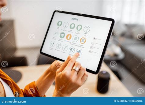 Woman Controlling Smart Devices With A Digital Tablet At Home Stock