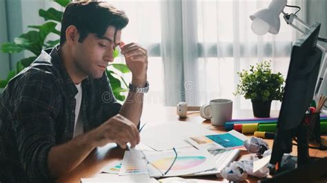 Top Down View Of Designer Working On Palettes And Crumpled Paper