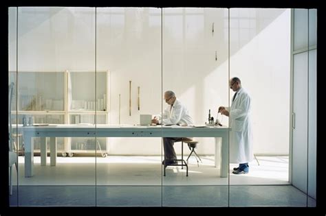 Premium Ai Image There Are Two Men In Lab Coats Sitting At A Table Generative Ai