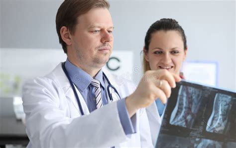 Two Doctors Are Carefully Examining Patient Medical History Stock Image