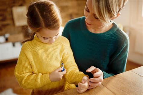 Madre Single Che Insegna Alla Figlia Piccola Come Usare Il Termometro A Casa Foto Gratis