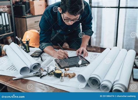 Engineering Working With Drawings Inspection On Tablet In The Office