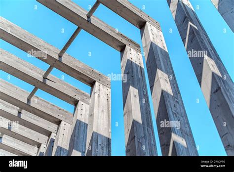 Modern Wooden Beam Structure With Geometric Patterns And Shadows Under