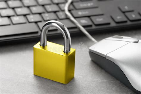 Locked Golden Padlock And Computer Mouse With Keyboard On The Table Cybersecurity Concept Stock