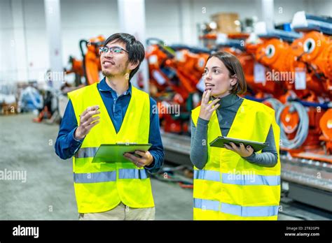 Japanese And Caucasian Engineers Reporting In Line Of Industrial