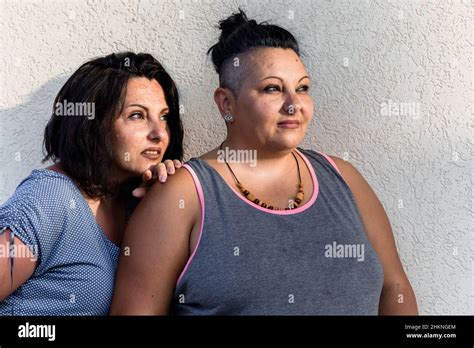 Portrait Of Two Adult Brunette Twin Sisters Looking At Something