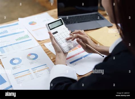 Financial Planning Marketing And Accounting Asian Woman Economist Using Calculator To