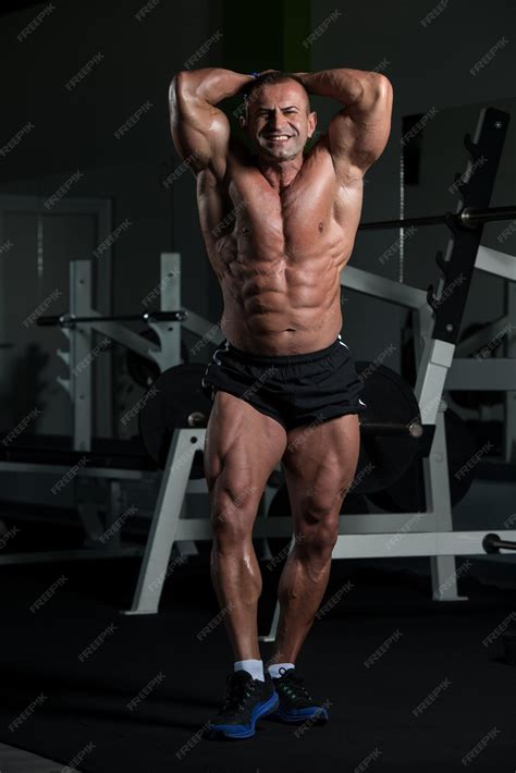 Premium Photo Handsome Mature Man Standing Strong In The Gym And