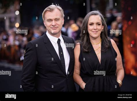 Director Christopher Nolan Left And Producer Emma Thomas Pose For