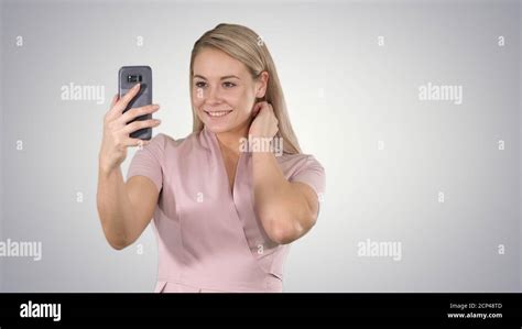 Happy Woman Takes Selfie Photo With Mobile Phone On Gradient Bac Stock