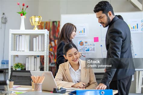 직장에서 이야기하는 아시아 비즈니스 팀 남성과 여성 동료는 노트북으로 아이디어를 공유하고 행복한 동료들은 사무실의 컴퓨터에서 함께 일합니다 20 29세에 대한 스톡 사진 및