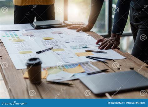 Group Of Ux Developer And Ui Designer Brainstorming About App Interface Design At Modern Office