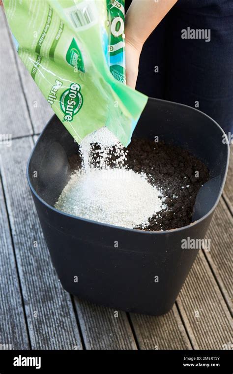 Mixing Two Types Of Compost In Bucket Stock Photo Alamy