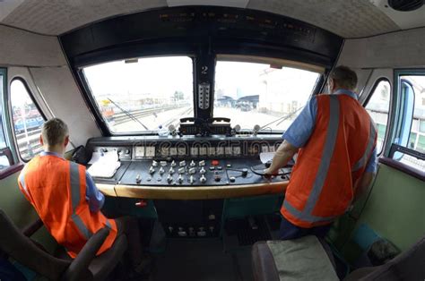 Train Drivers Driving Passenger Train Sitting In The Cabin In Front Of