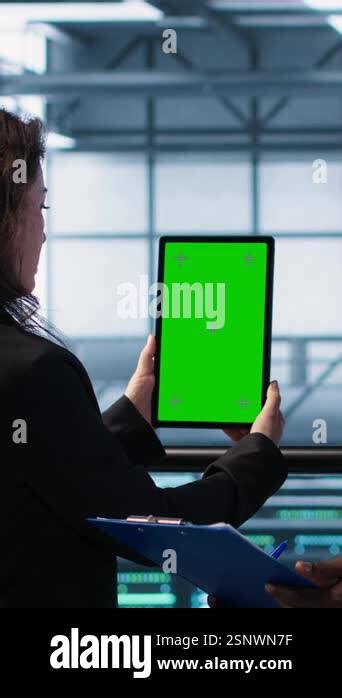 Vertical Video Computer Scientists In Data Center Use Mockup Tablet Inspecting Server Rigs
