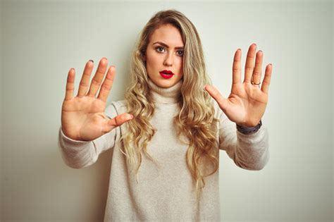 고립 된 흰색 배경 위에 겨울 터틀넥 스웨터를 입은 아름다운 여성은 손바닥 화가 나고 좌절하는 표정으로 제스처를 멈추고 있습니다 가을에 대한 스톡 사진 및 기타 이미지